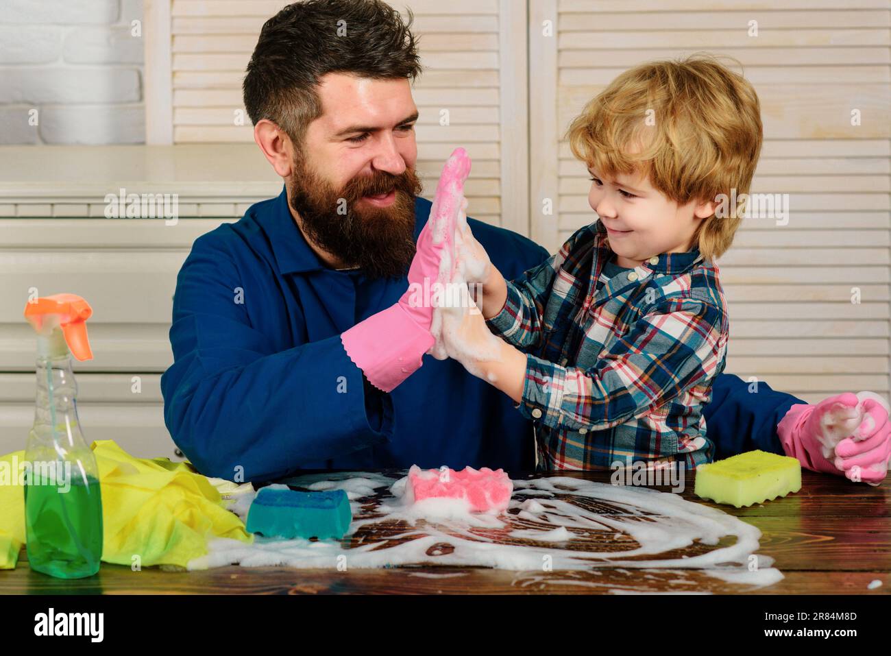 Dad and child doing cleaning at home. Father and son with cleaning ...