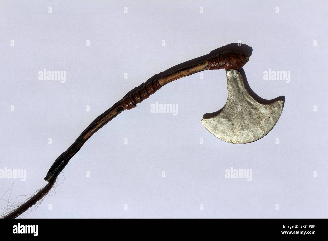 An hatchet made of wood, metal and leather. An old hatchet on a white ...