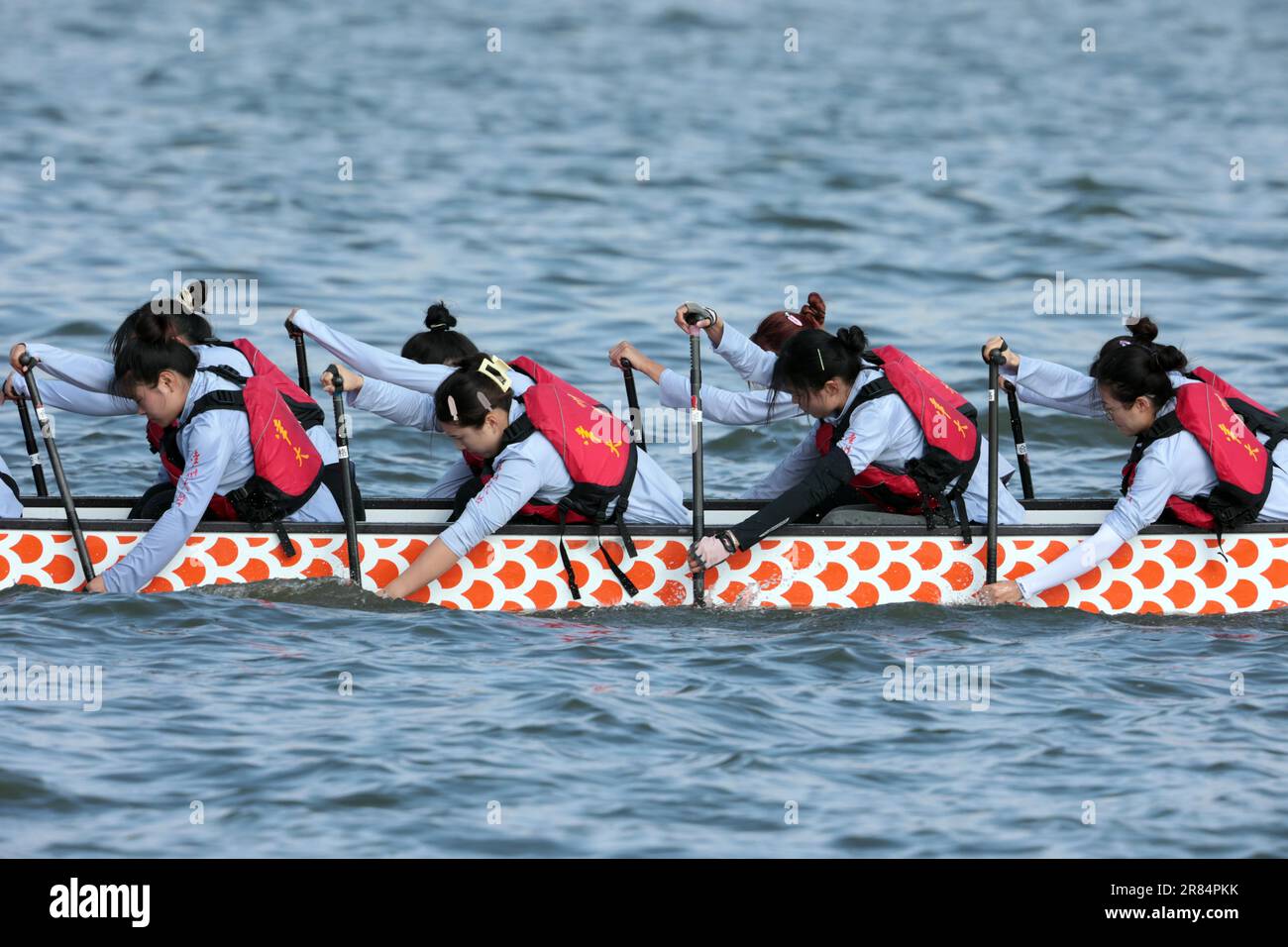People compete at a dragon boat racing event in Kunming City, southwest ...