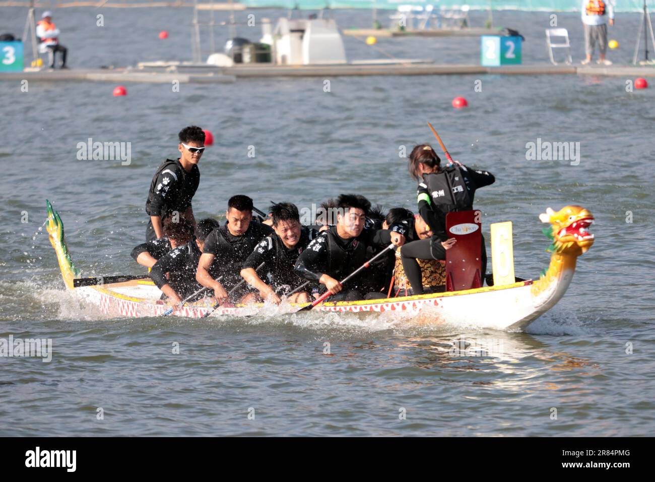 People compete at a dragon boat racing event in Kunming City, southwest ...