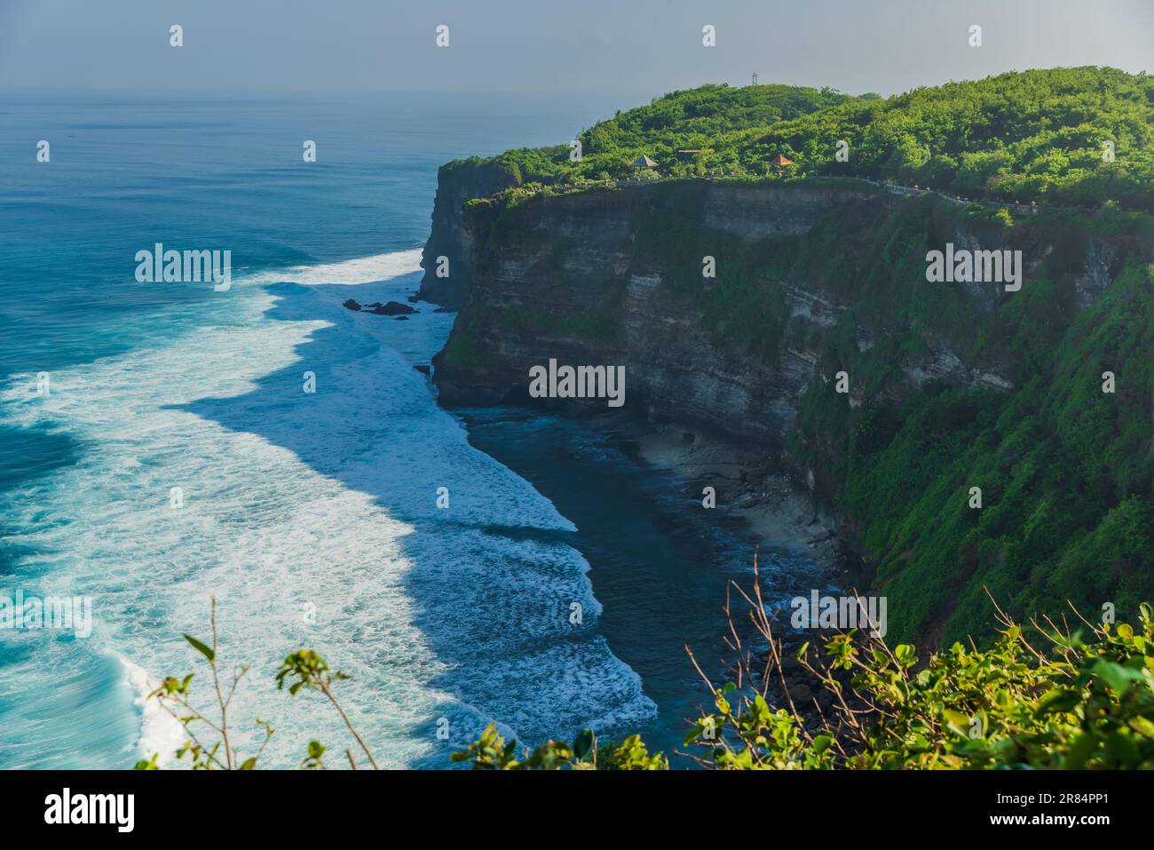 Scenic rocky cliff and ocean with waves in Uluwatu, Bali. Popular ...