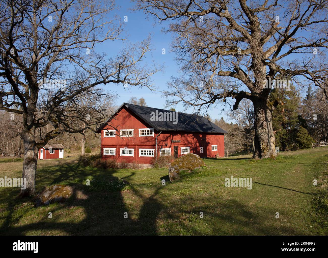 MÄLARDALEN, SWEDEN ON MAY 11, 2023. View of a red, wooden, well ...