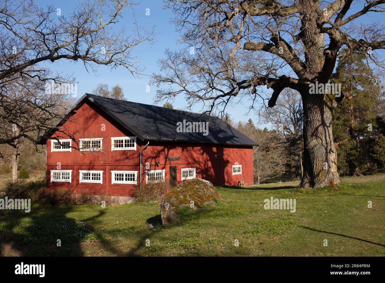 MÄLARDALEN, SWEDEN ON MAY 11, 2023. View of a red, wooden, well ...