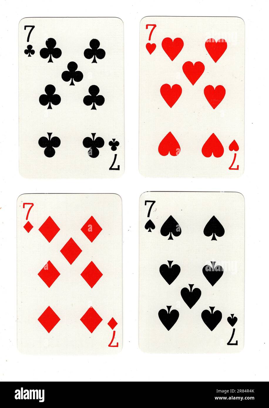 Vintage playing cards featuring four sevens on a white background Stock ...