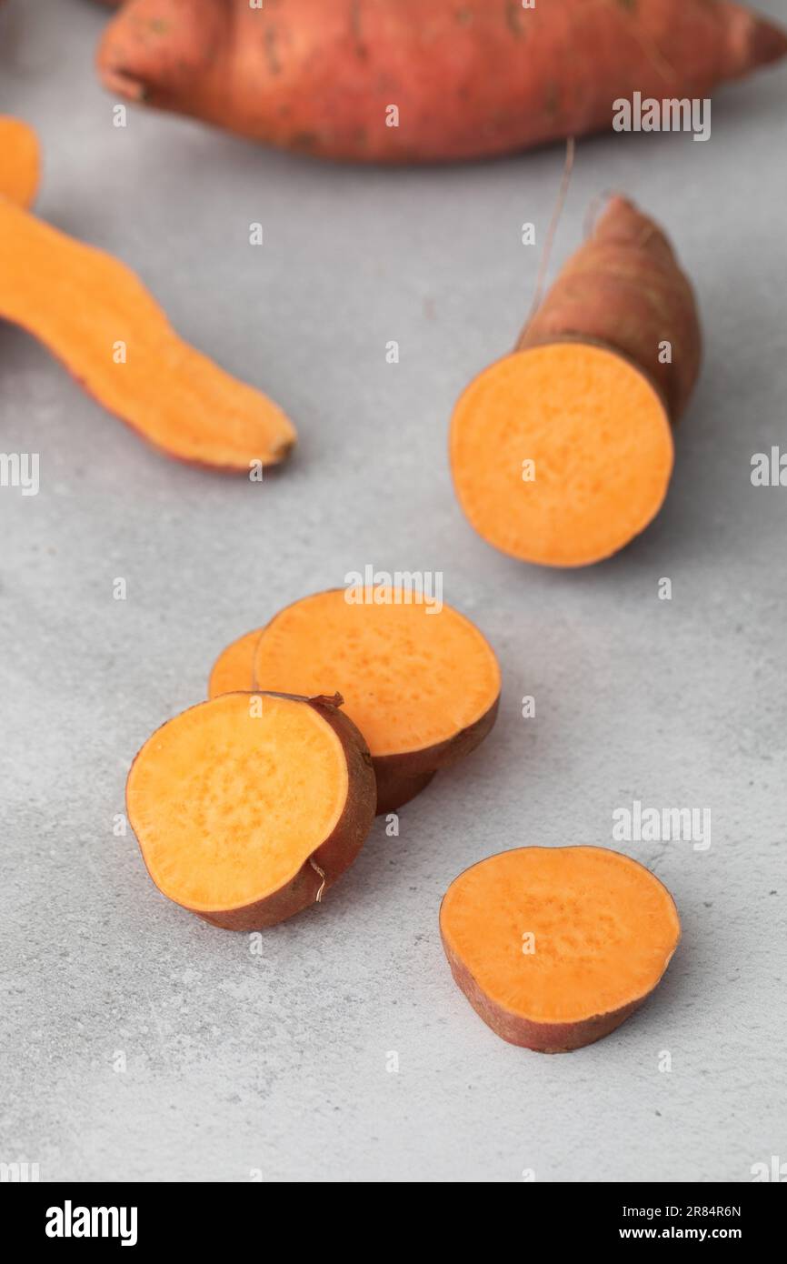 Raw sweet potatoes whole and cut. Orange kumara, sweet potato ...