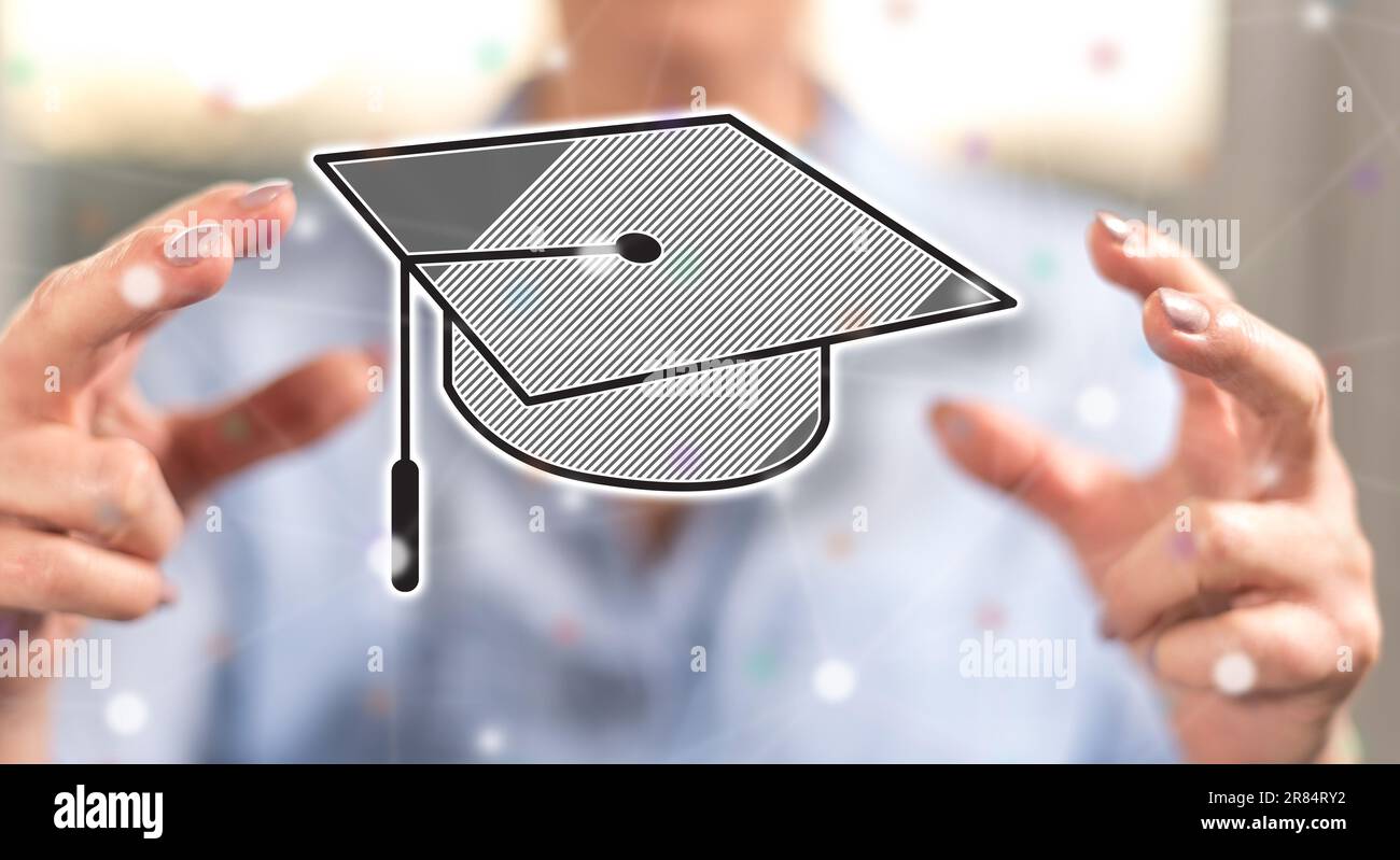 Graduation concept between hands of a woman in background Stock Photo ...