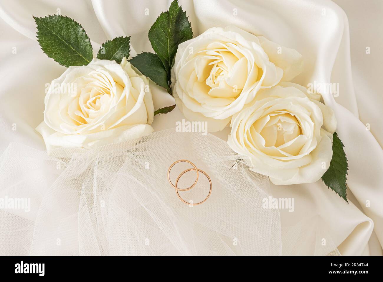 A beautiful wedding arrangement with a pair of wedding gold rings on a ...