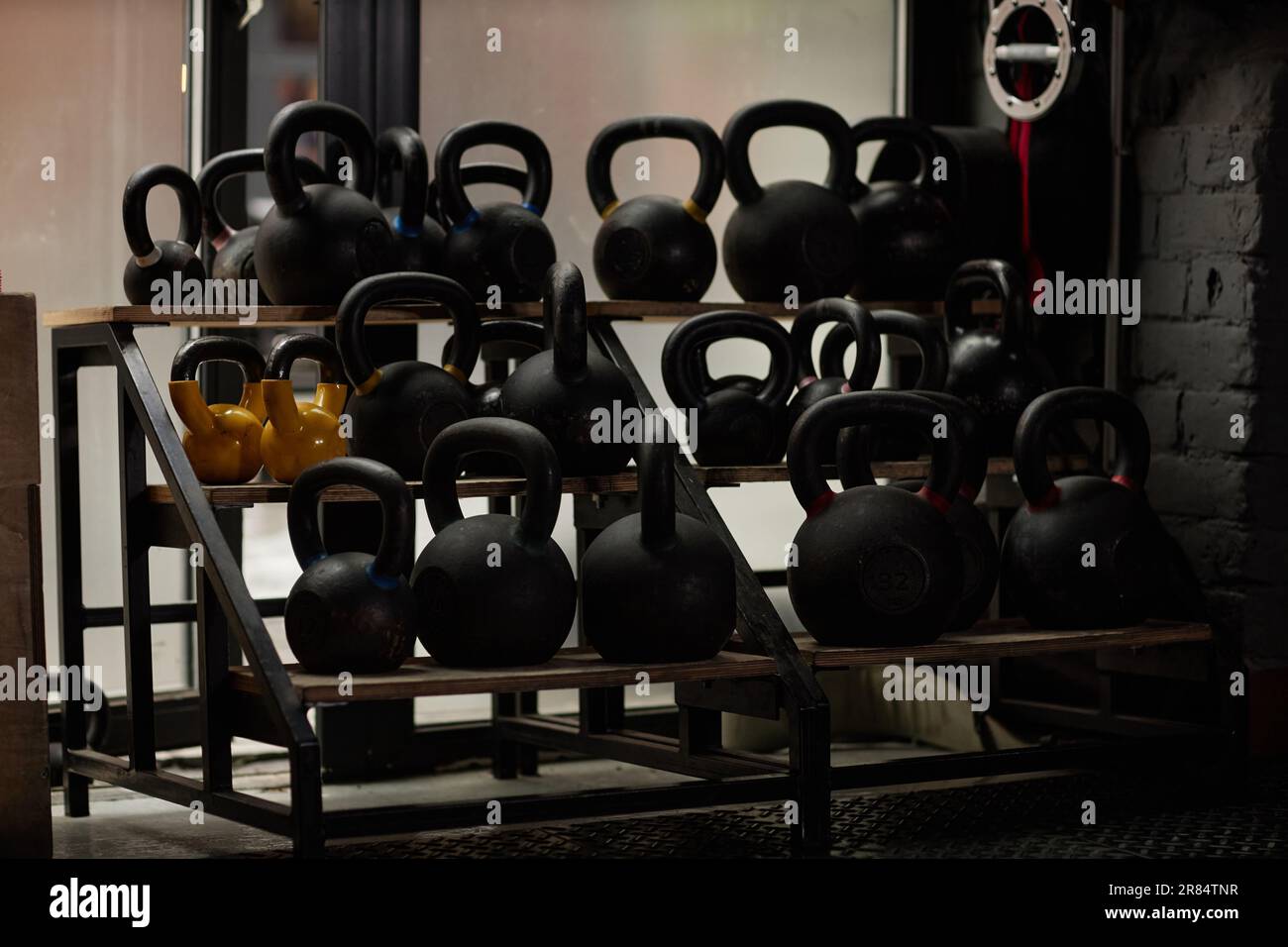 Large display with group of heavy kettlebells of black and yellow color ...