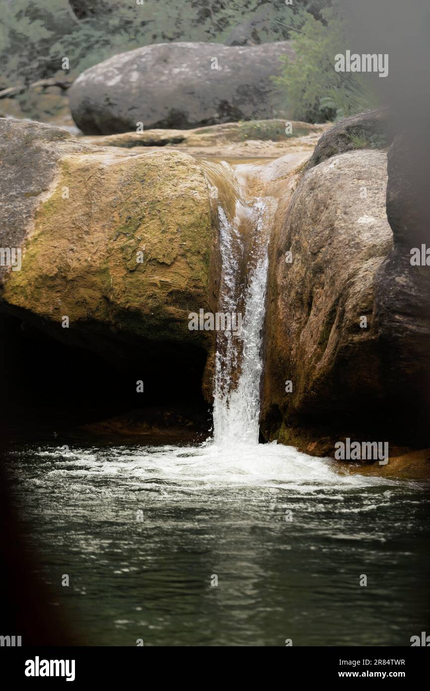 A waterfall cascading down a rocky cliff face Stock Photo - Alamy