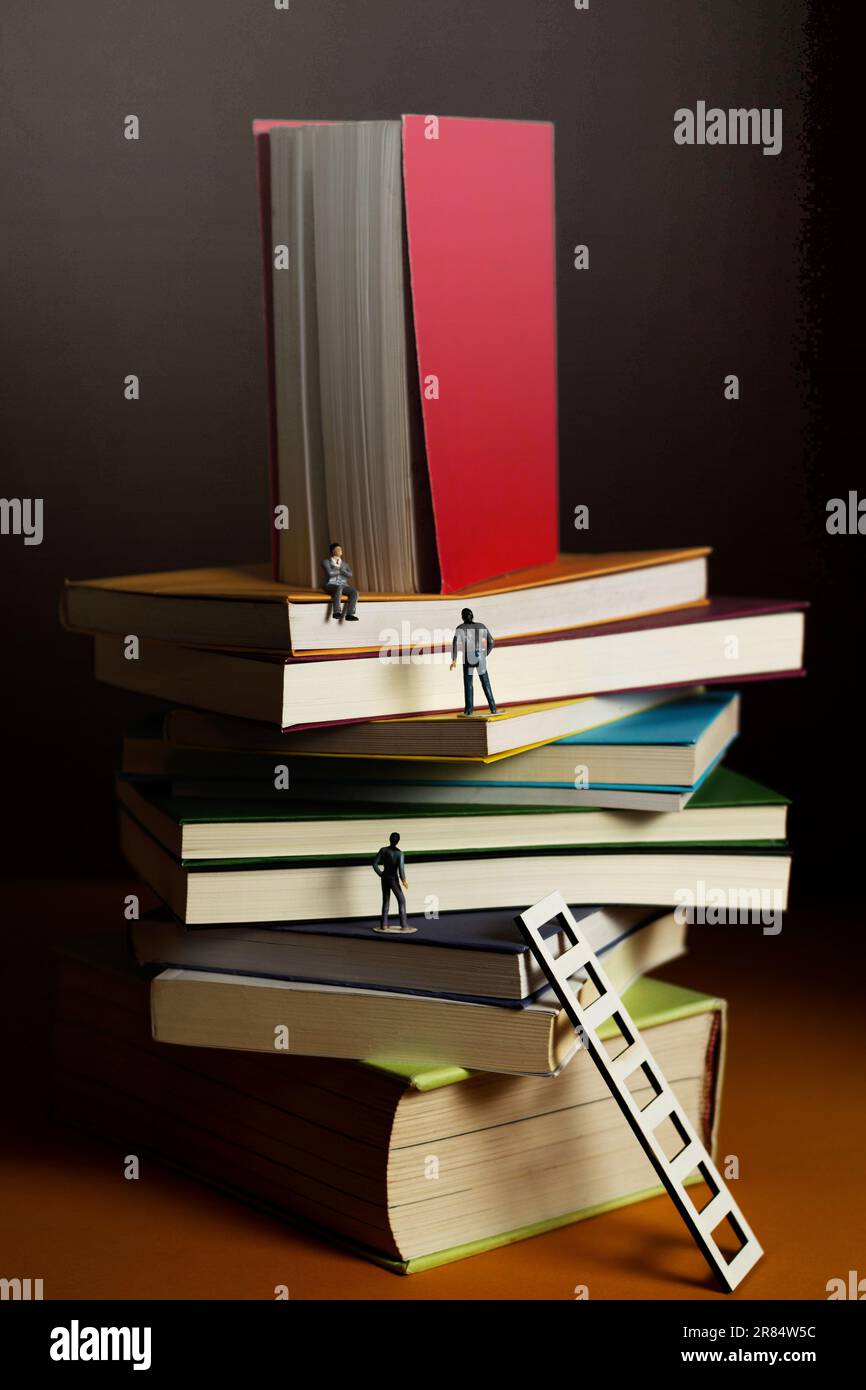 A small toy figure is ascending a staircase composed of colorful books ...