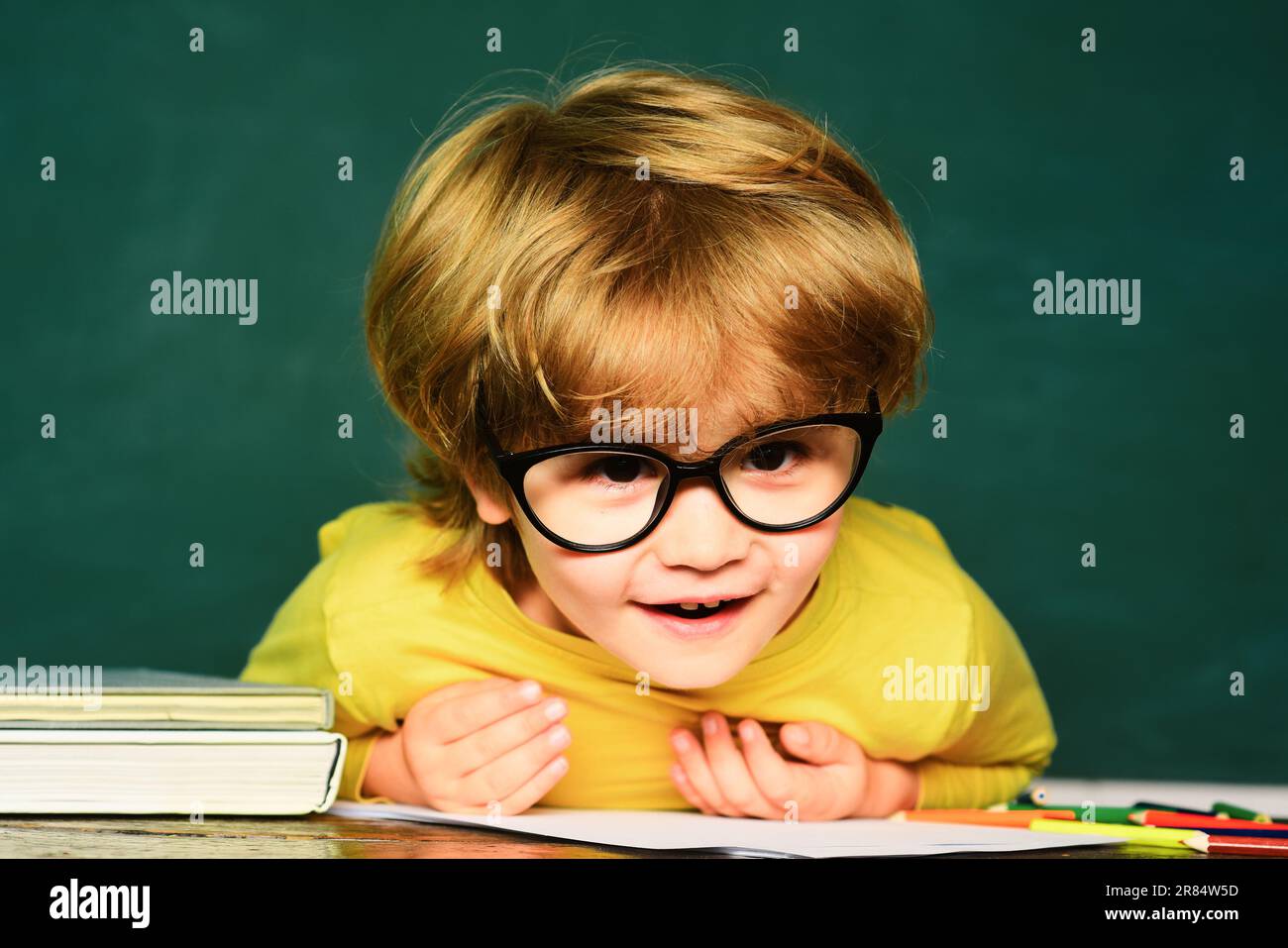 School kids against green chalkboard. Blackboard background ...
