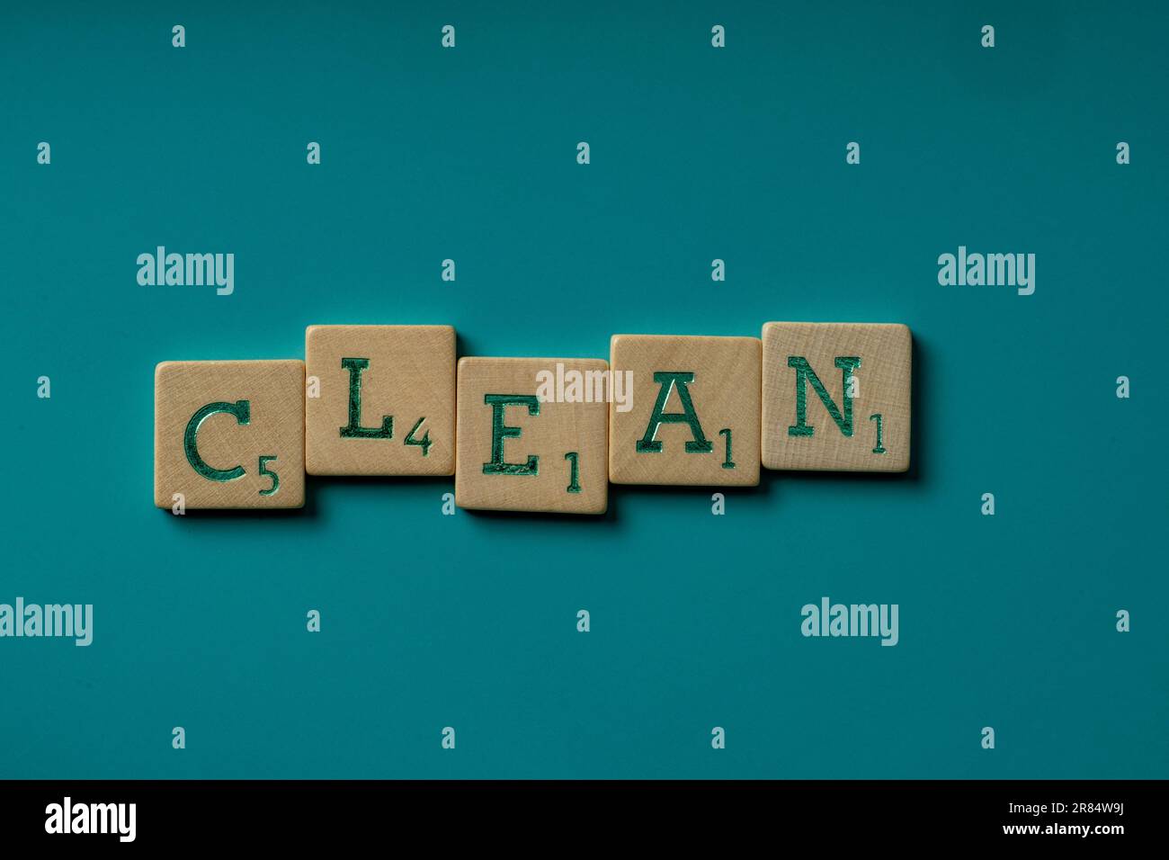 The wooden letters spelling the word clean on a blue background Stock ...