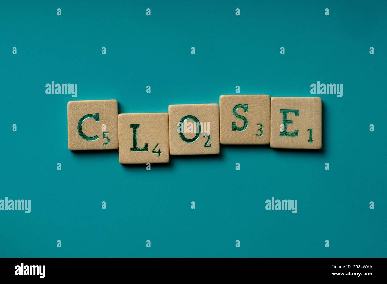 The wooden letters spelling the word close on a blue background Stock ...
