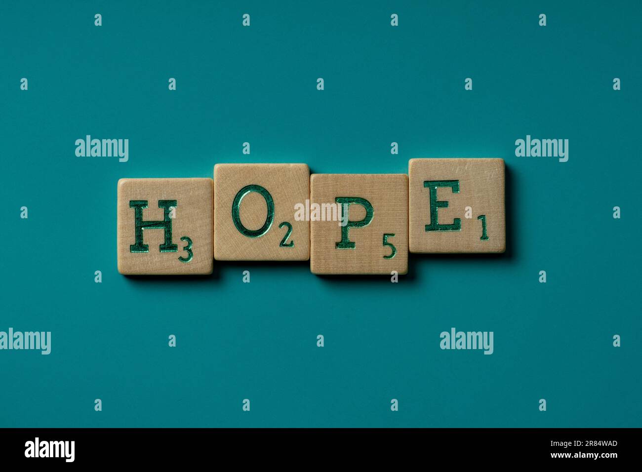 The wooden letters spelling the word hope on a blue background Stock ...