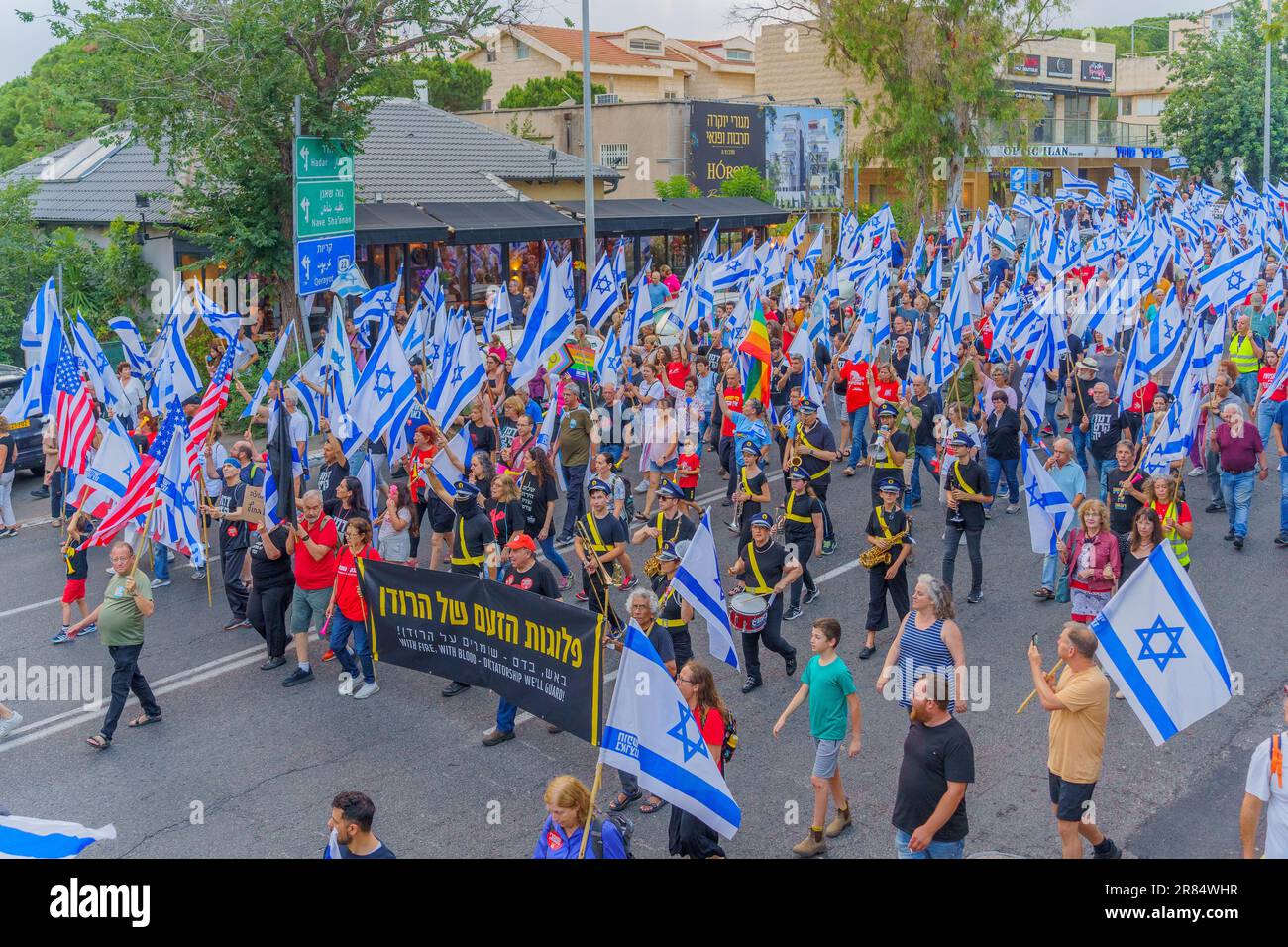 Haifa, Israel - June 17, 2023: People marching with flags and various ...