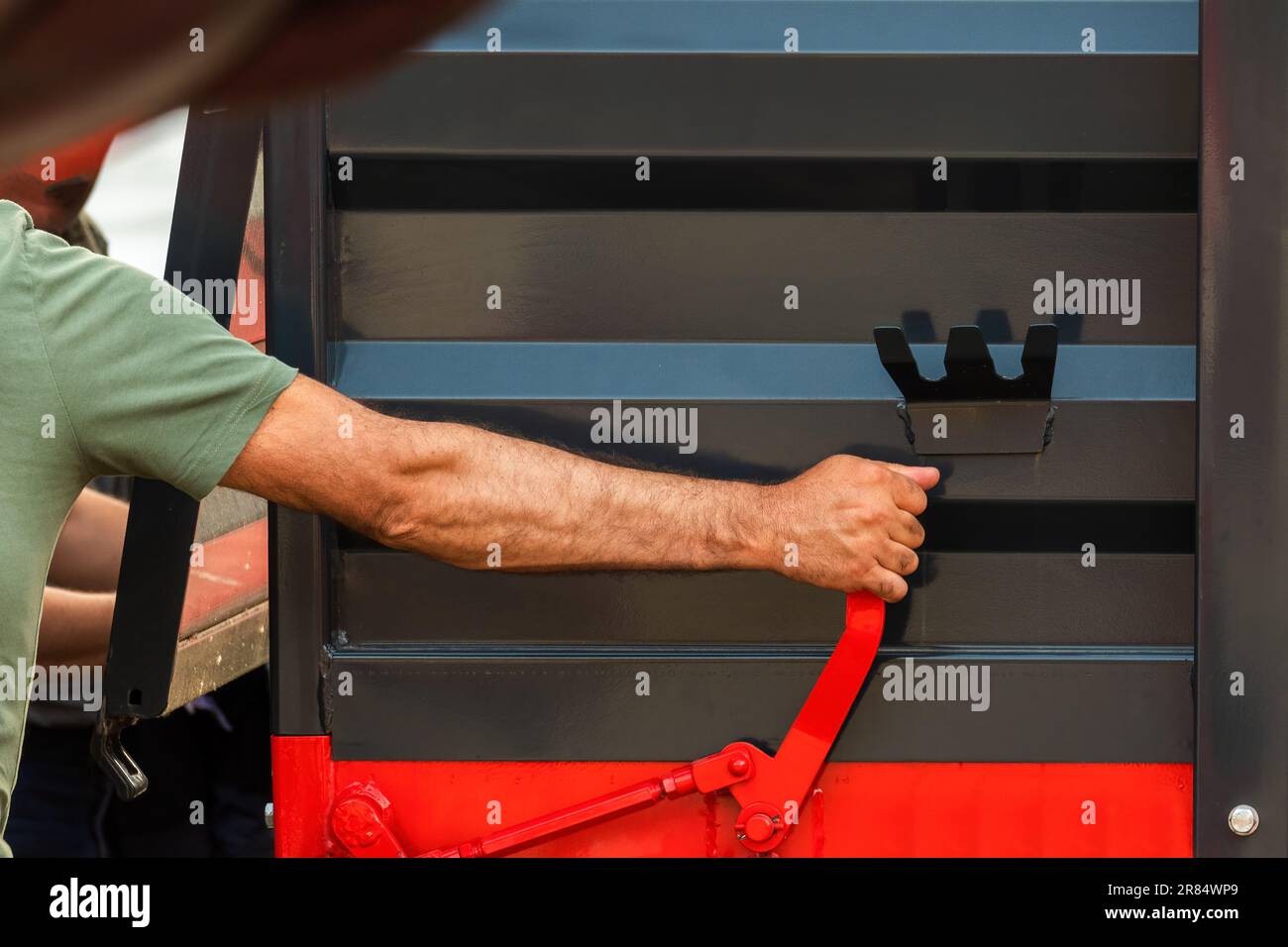 Farmer opening agricultural tractor trailer, selective focus Stock ...