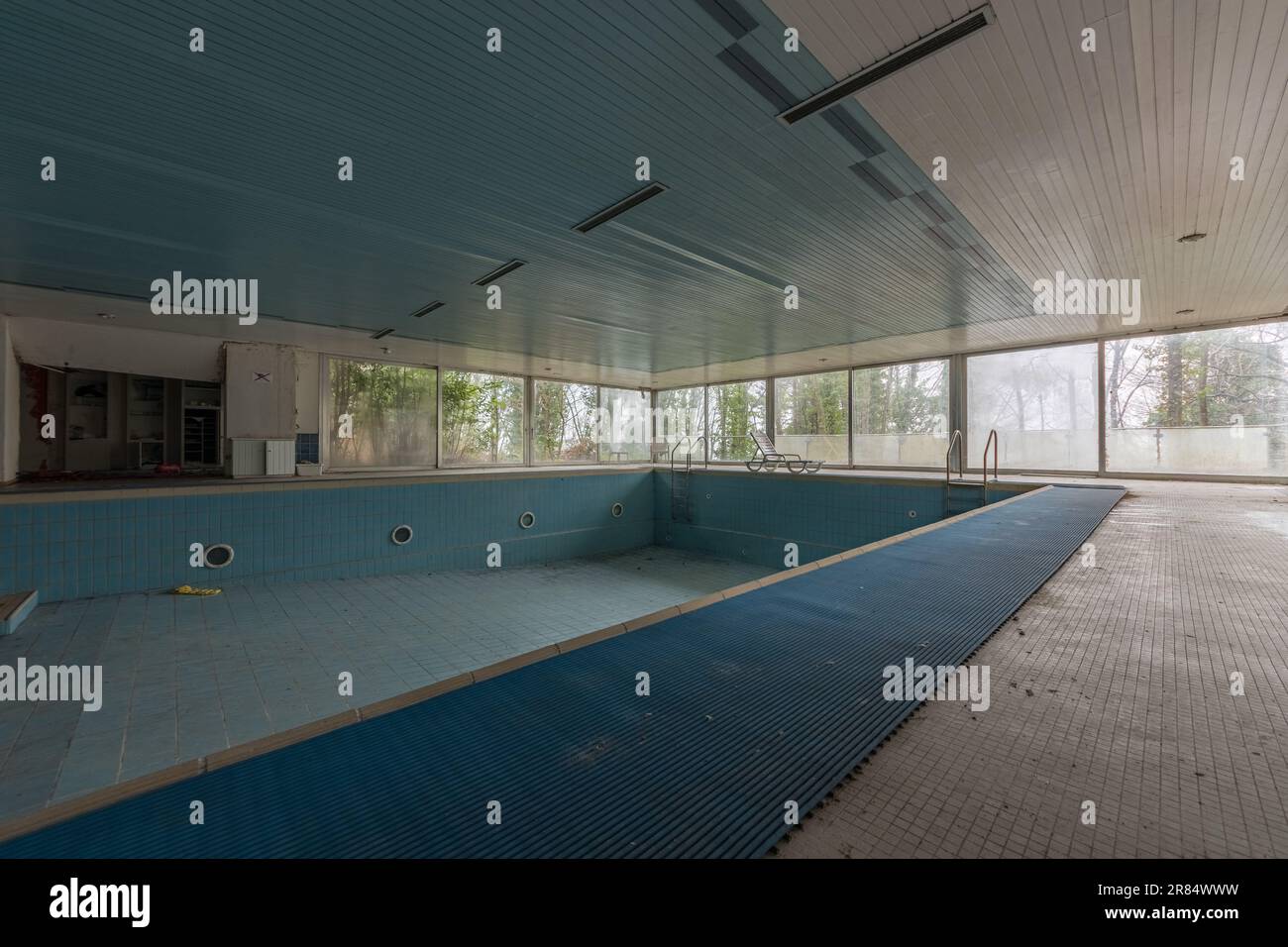 Old swimming pool or indoor pool without water which is no longer used ...