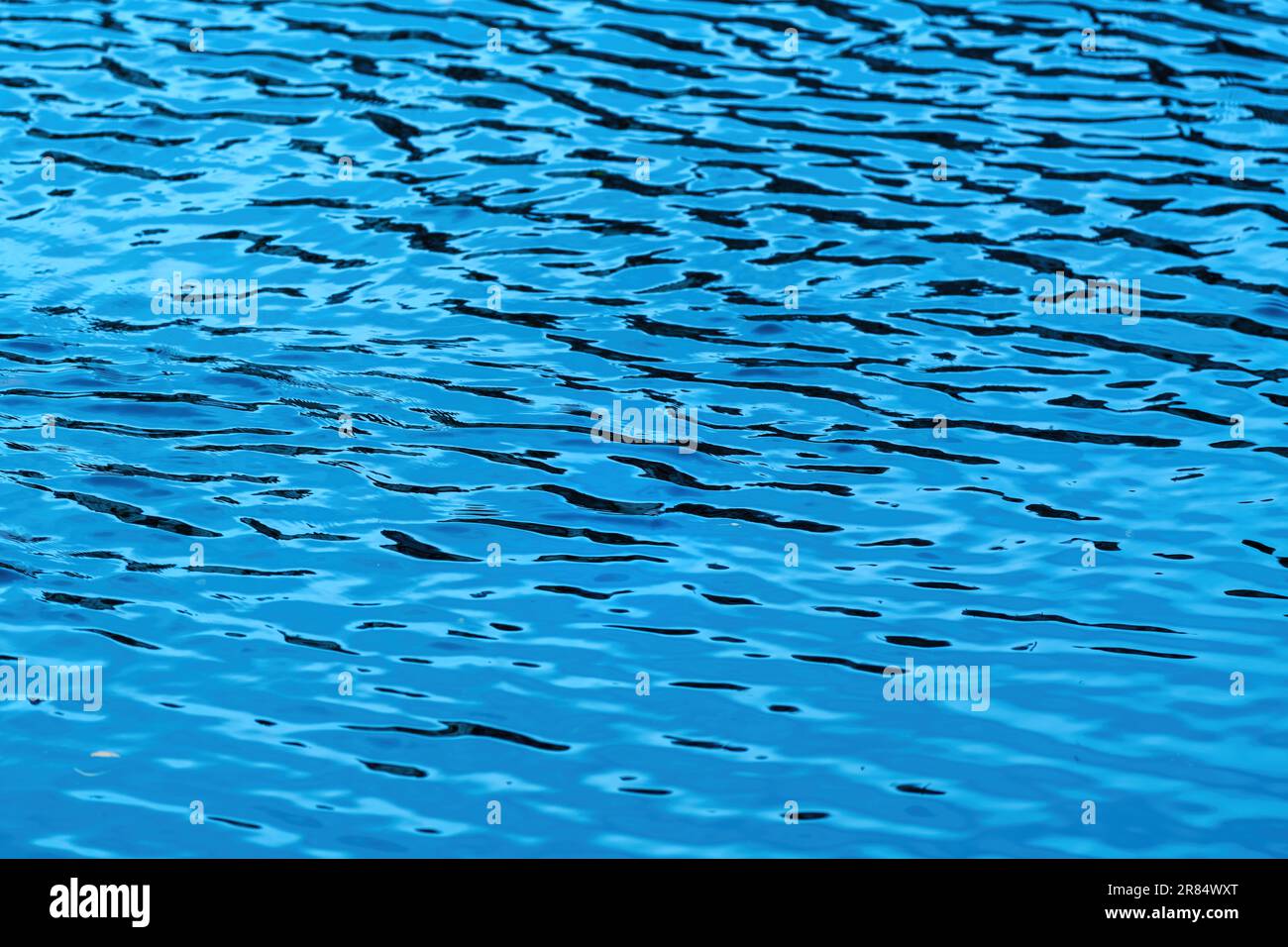 Blue river water surface with ripples and light reflection. Texture of ...