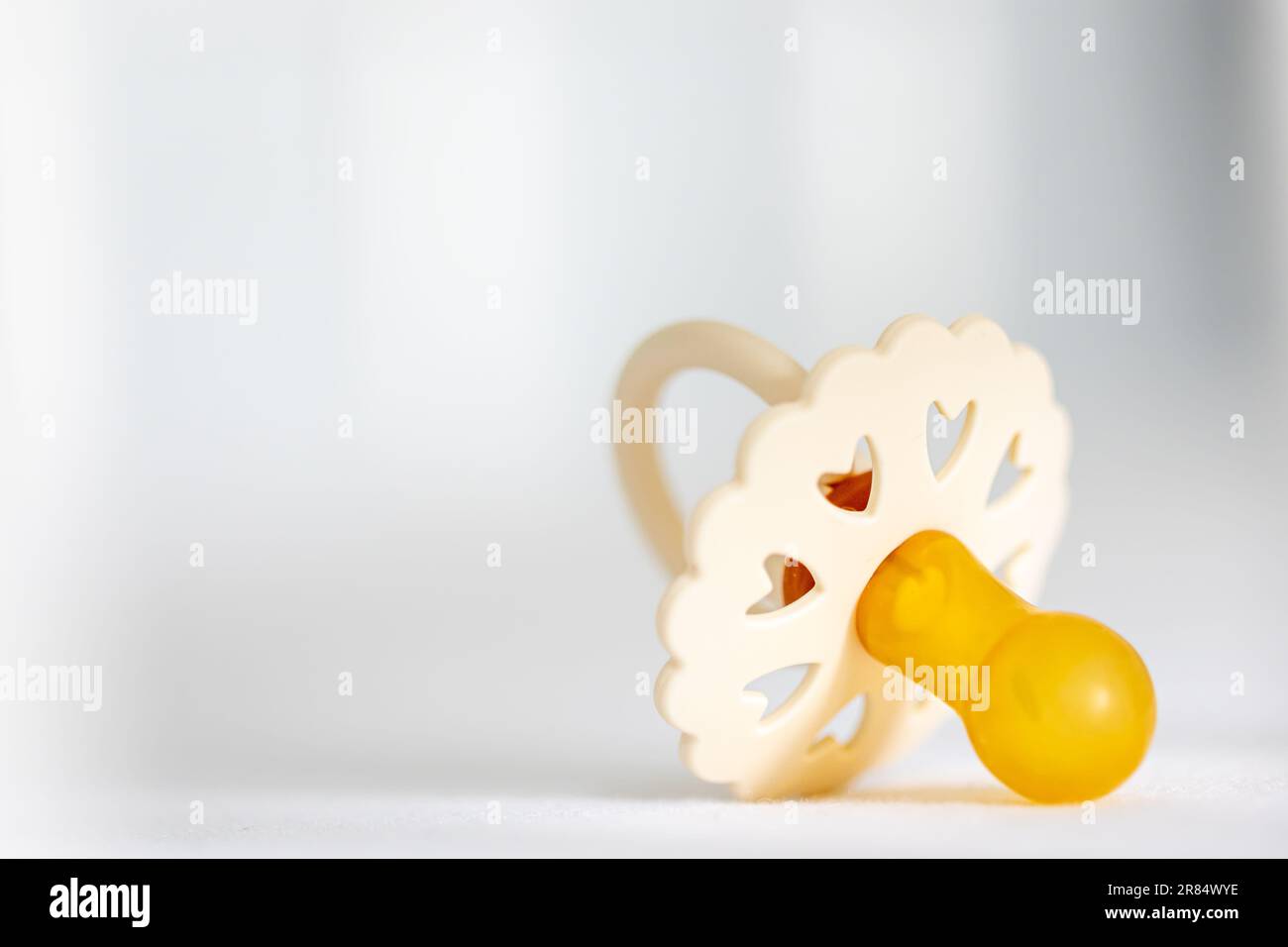 Baby's pacifier on a blurred white background Stock Photo - Alamy