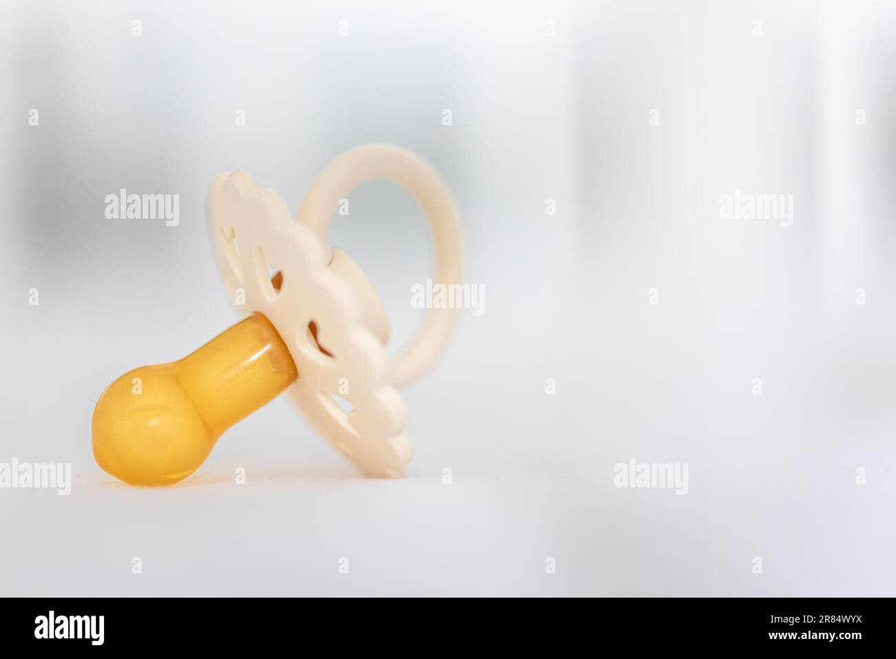 Baby's pacifier on a blurred white background Stock Photo - Alamy