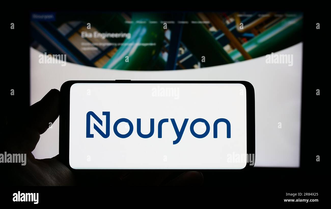 Person holding mobile phone with logo of Dutch company Nouryon ...