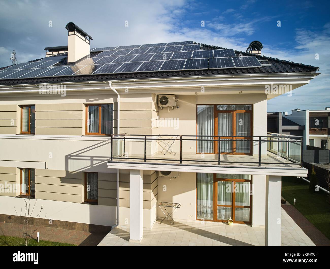 New two-storey house with photovoltaic solar panels on rooftop. Home ...