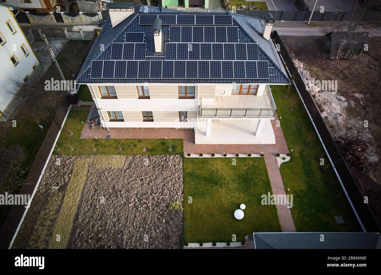 Aerial drone view of house with photovoltaic solar panels on rooftop ...