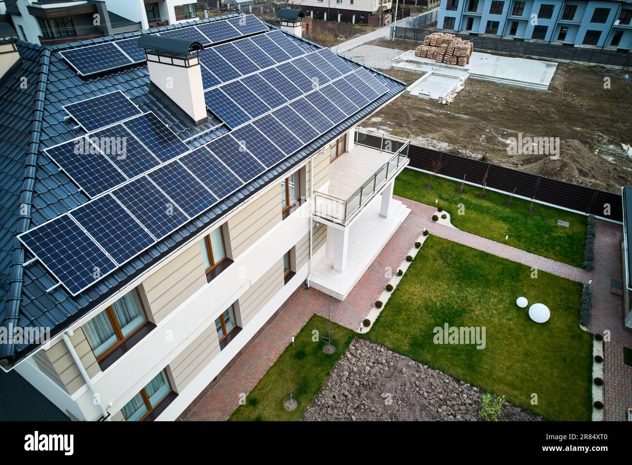 Residential house with photovoltaic solar panel modules on rooftop and ...