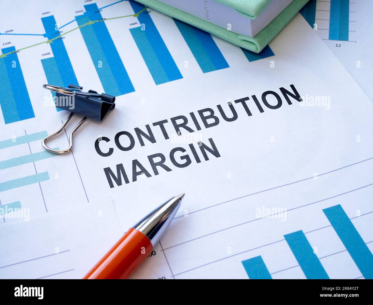 Papers with contribution margin calculation and charts Stock Photo - Alamy
