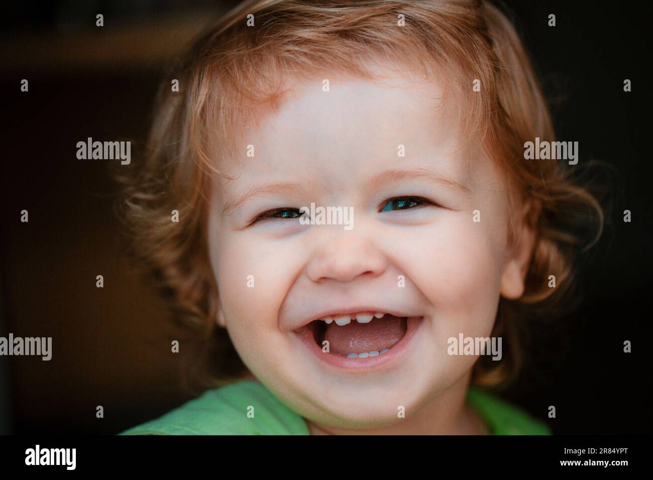 Portrait of a happy laughing child. Smiling infant, cute smile. Close ...