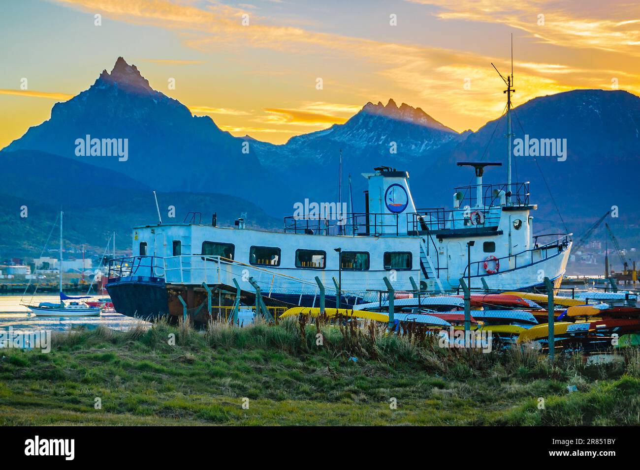 Antique ship parked at ushuaia port with andes range mountains at ...