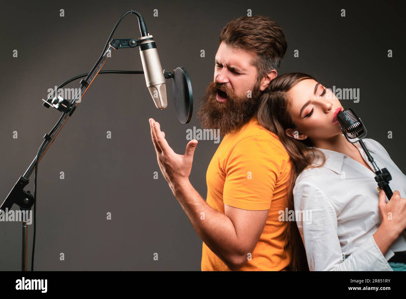 Couple singing. Singer coupl is performing a song with a microphone ...