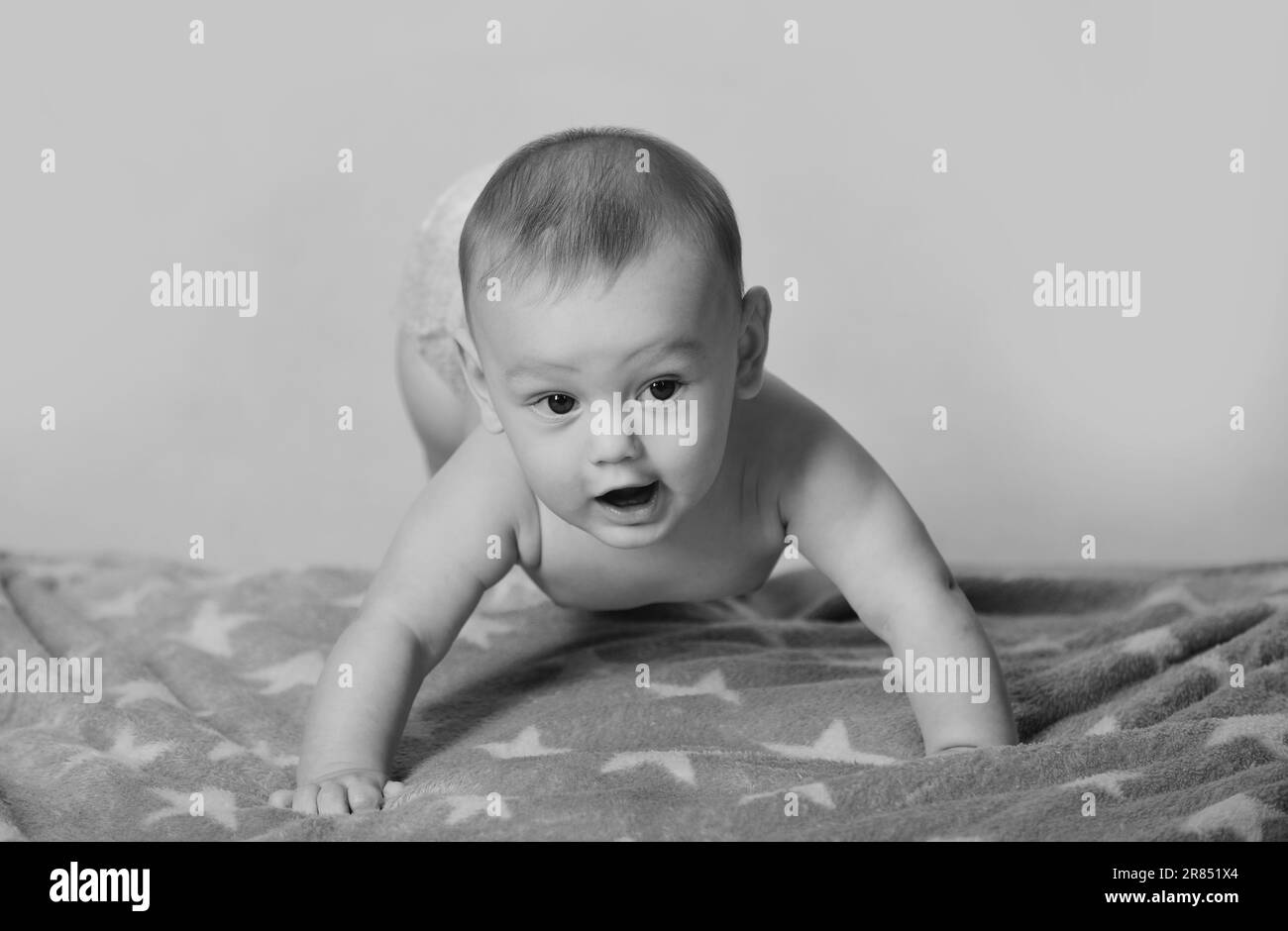 Little baby crawling on the bed. Happy kid playing. Cute little baby in ...