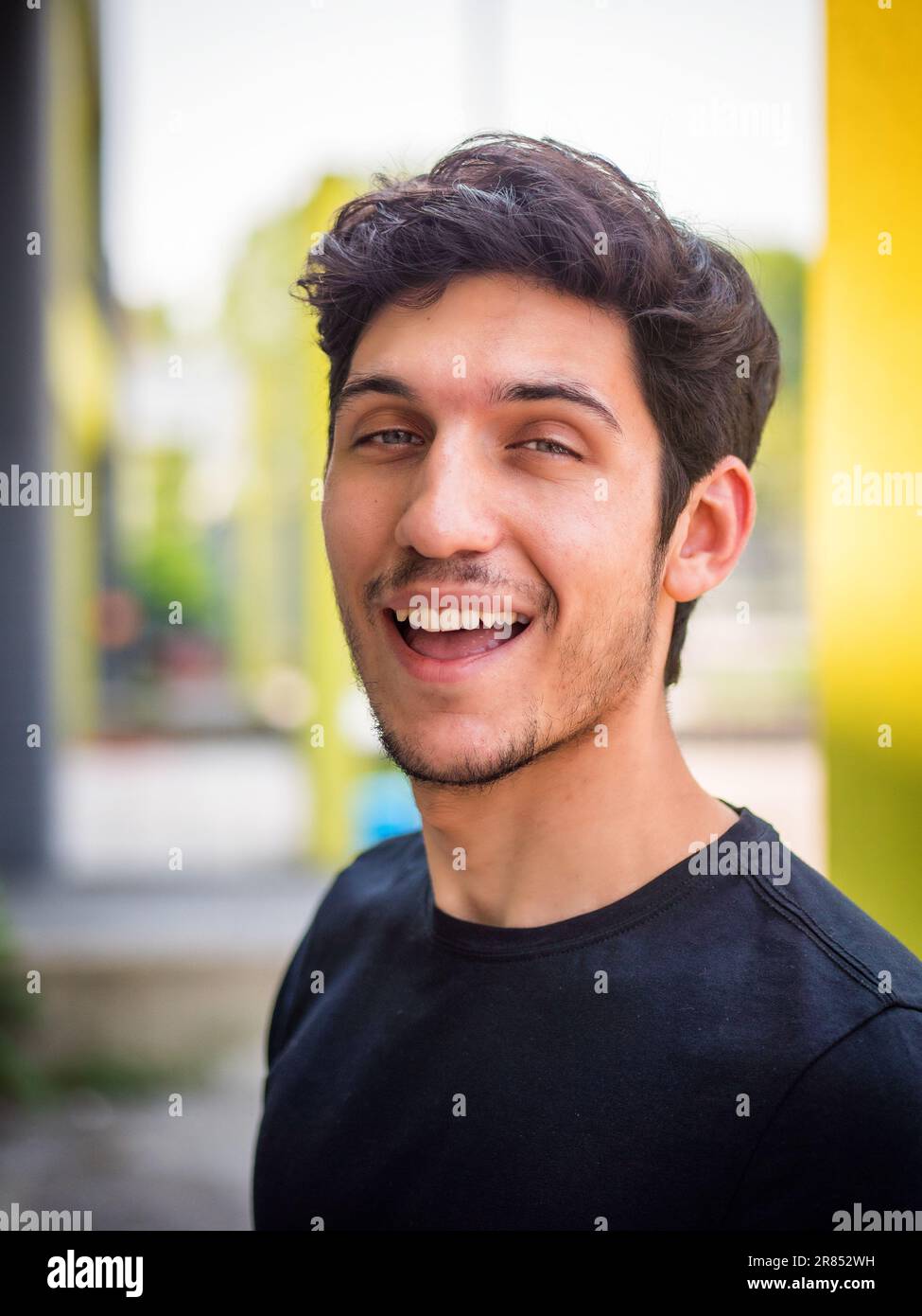 Head and shoulder shot of one handsome young man laughing Stock Photo ...