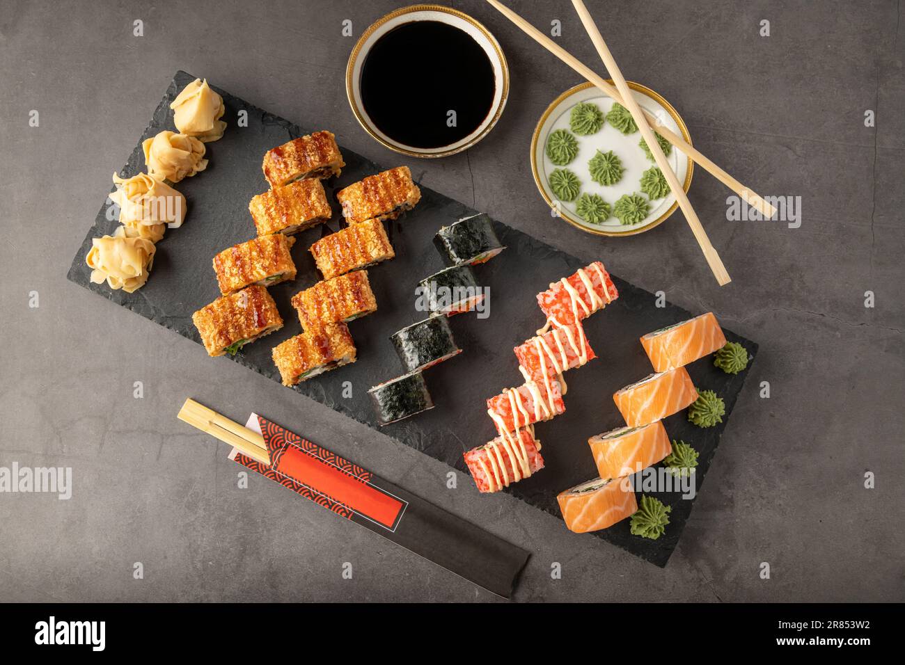 Sushi set of various products on a black stone plate. Blur background ...
