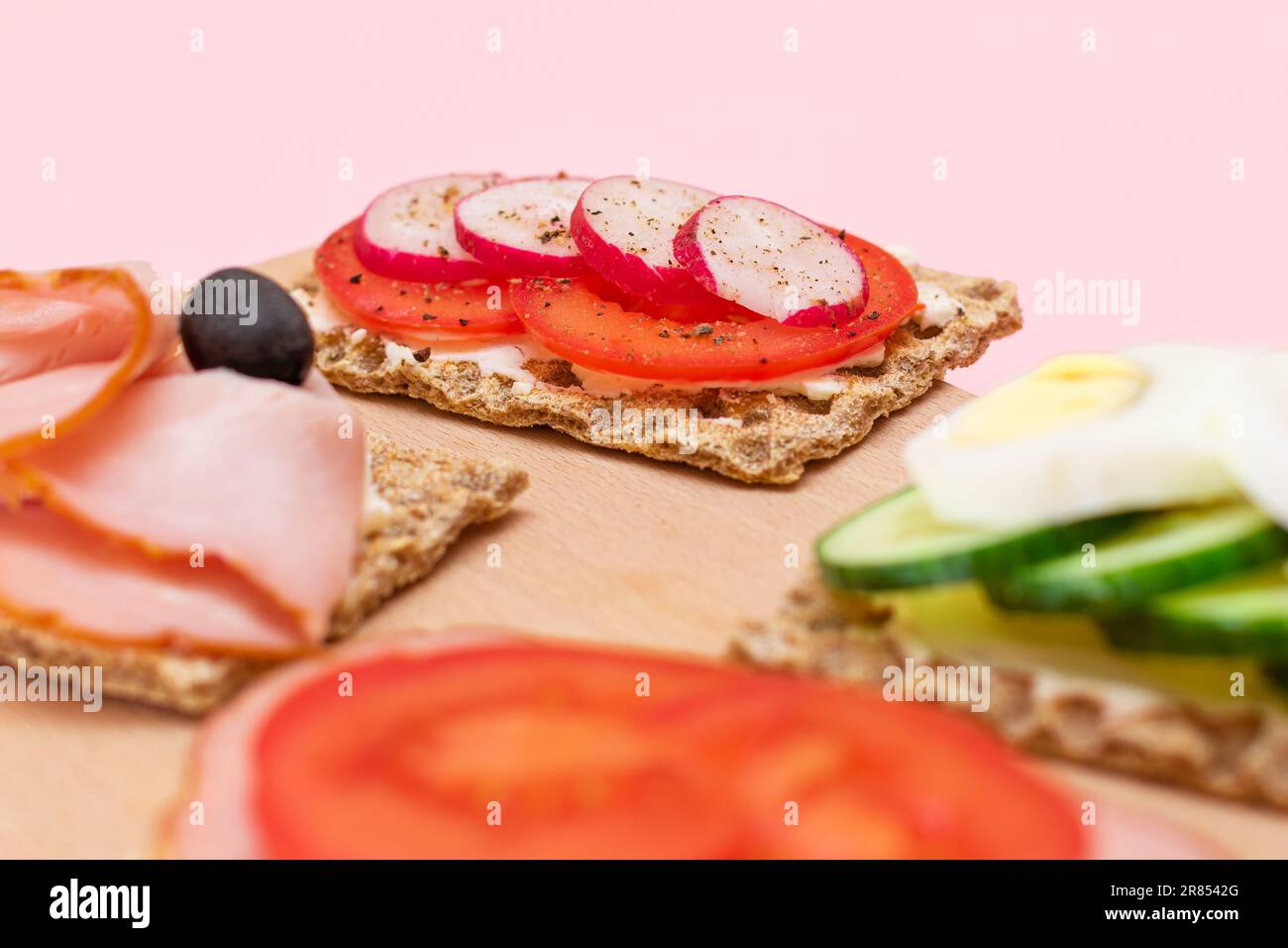 Different Whole Grain Crispbread with Ham, Tomato, Radish, Cucumber and ...