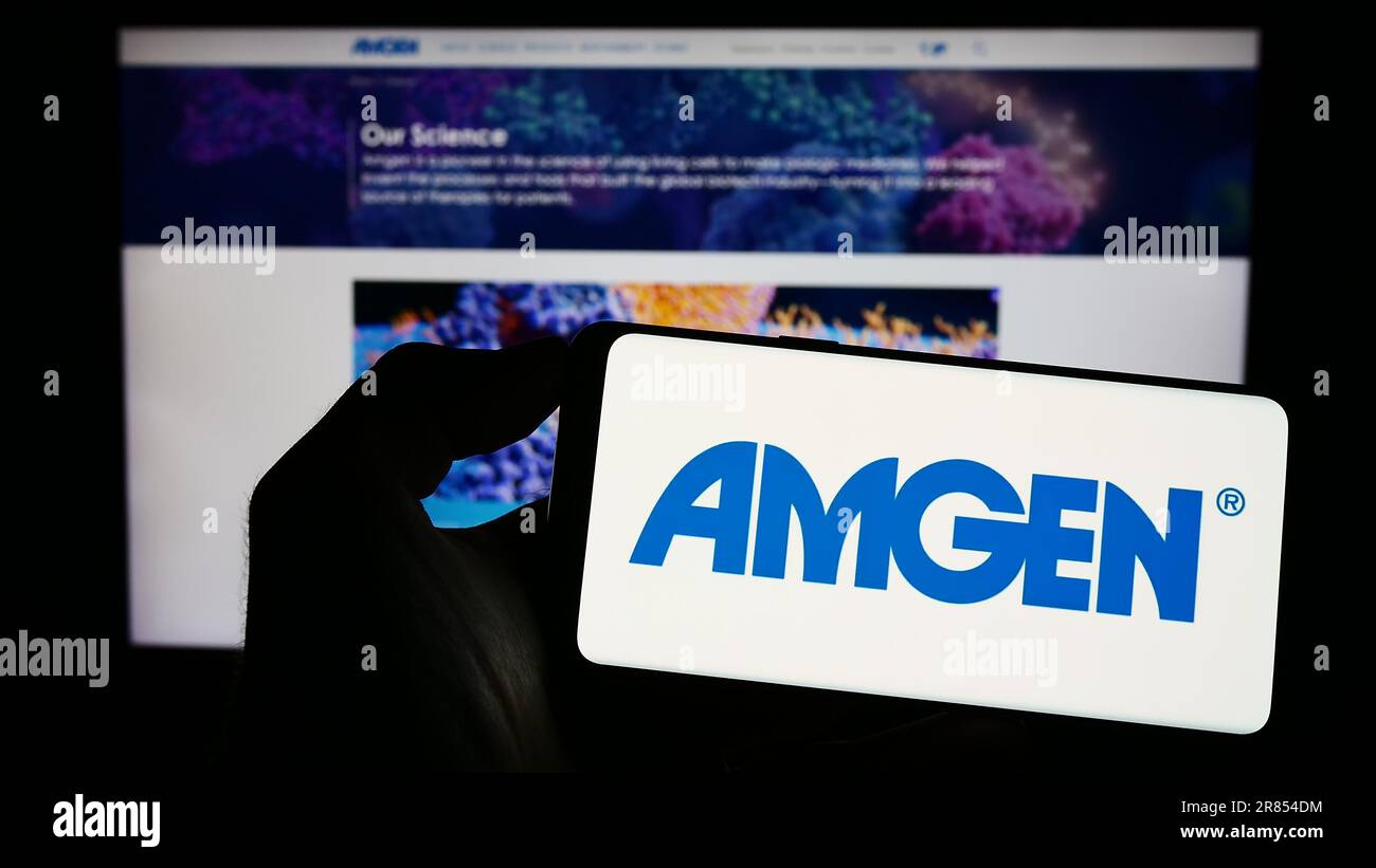 Person holding cellphone with logo of US biopharmaceutical company ...