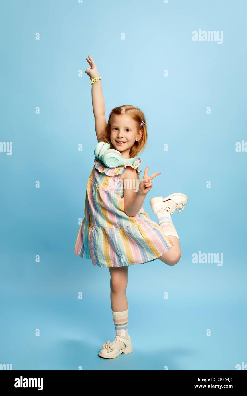 Full-length portrait of pretty, little, redhead girl, child in cute ...