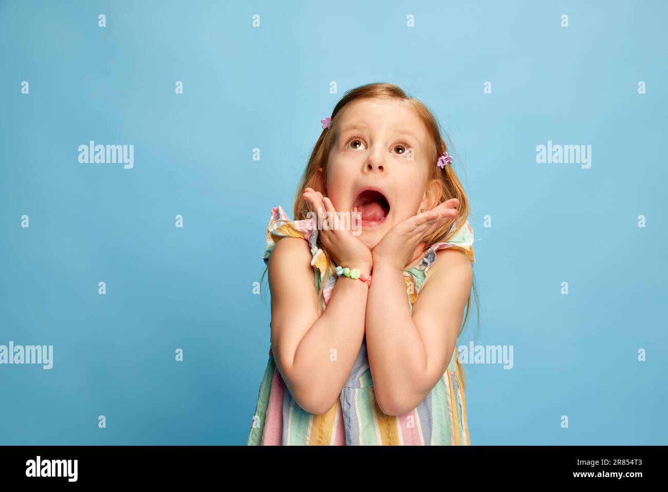 Portrait of little emotive girl, child standing with shocked face, wide ...