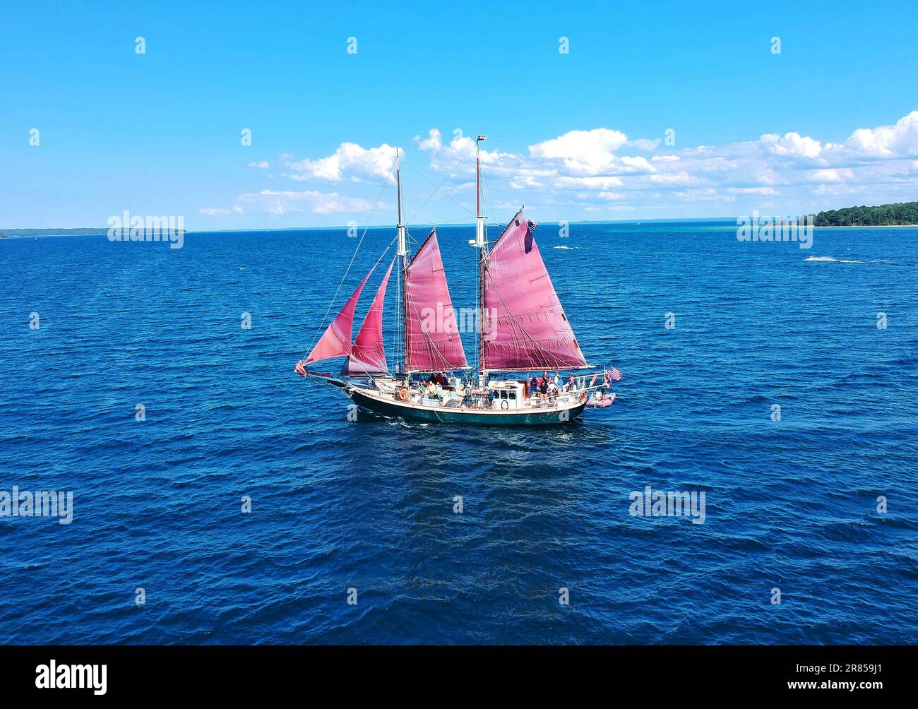 A pink sailboat floating on water Stock Photo - Alamy