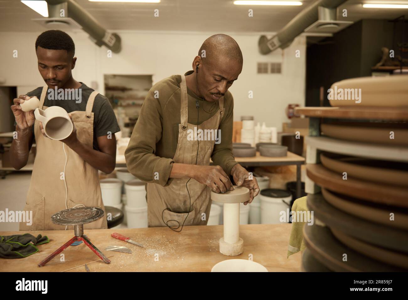 African ceramists working with molds in a pottery workshop Stock Photo ...