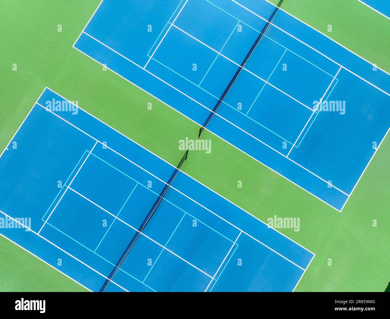 Aerial photo of blue tennis courts with white lines and light blue ...