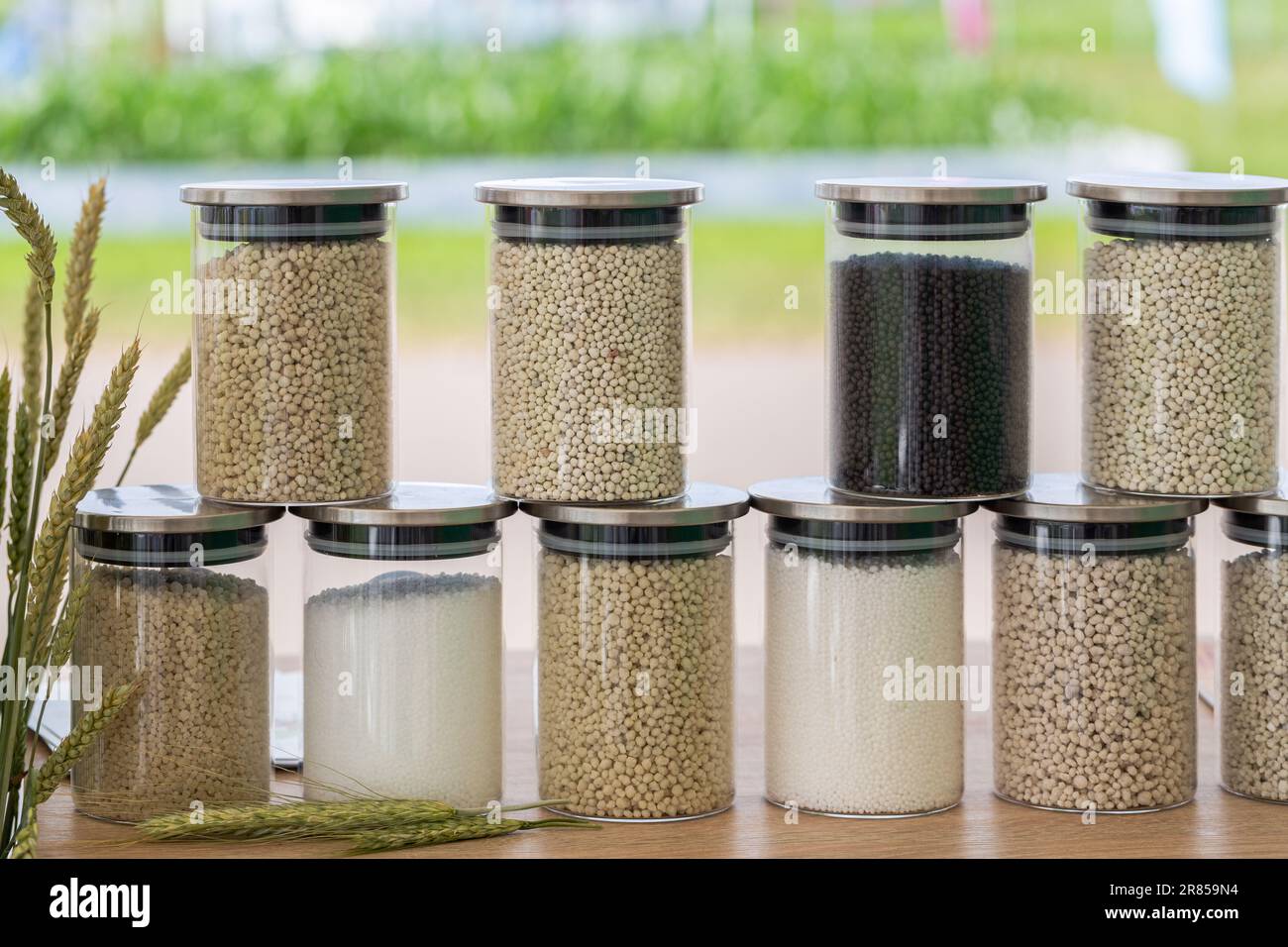 Chemical fertilizers in glass jars on a blurred background Stock Photo ...