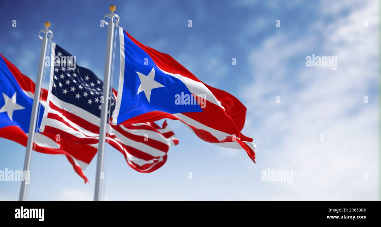 Flag of Puerto Rico waving with the United States flag on a clear day ...