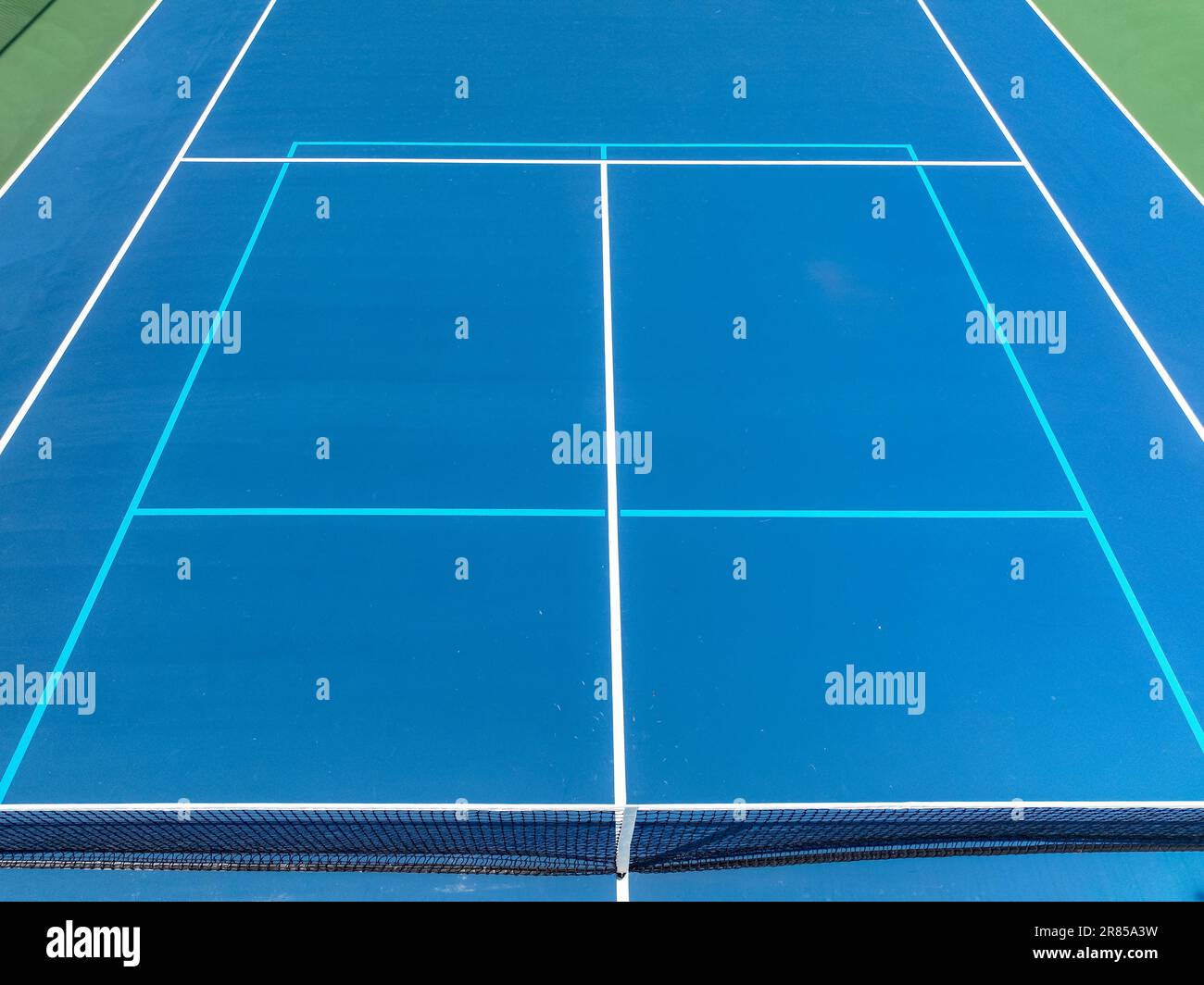 Aerial photo of blue tennis courts with white lines and light blue ...