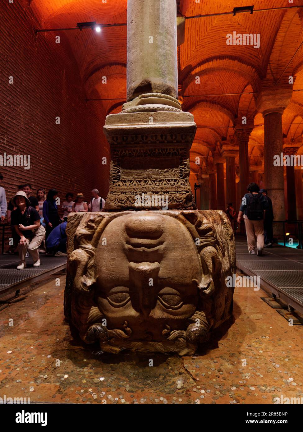 Inside the ancient Basilica Cistern, Istanbul, Turkey. A face is carved ...