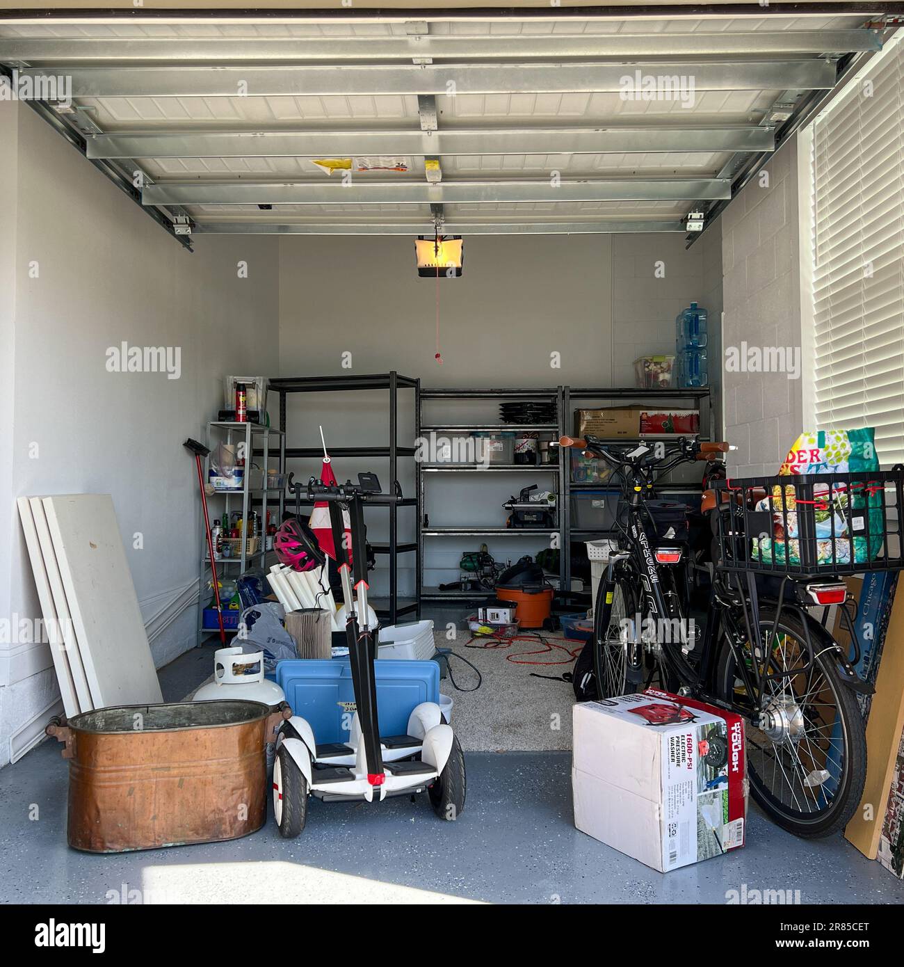 Orlando, FL USA - March 3, 2022: An unorganized garage filled with a ...