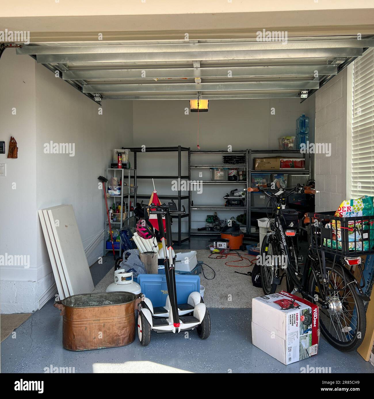 Orlando, FL USA - March 3, 2022: An unorganized garage filled with a ...