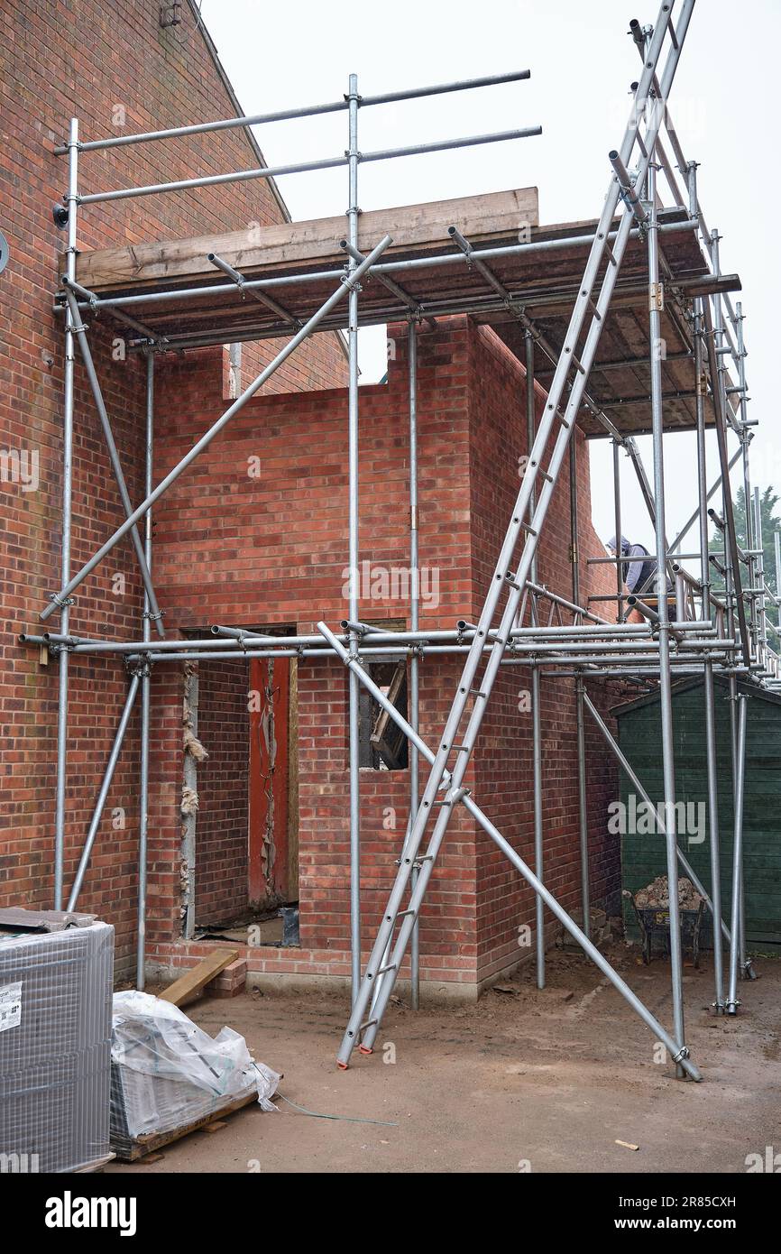 A brick building in the process of construction, with a metal ...