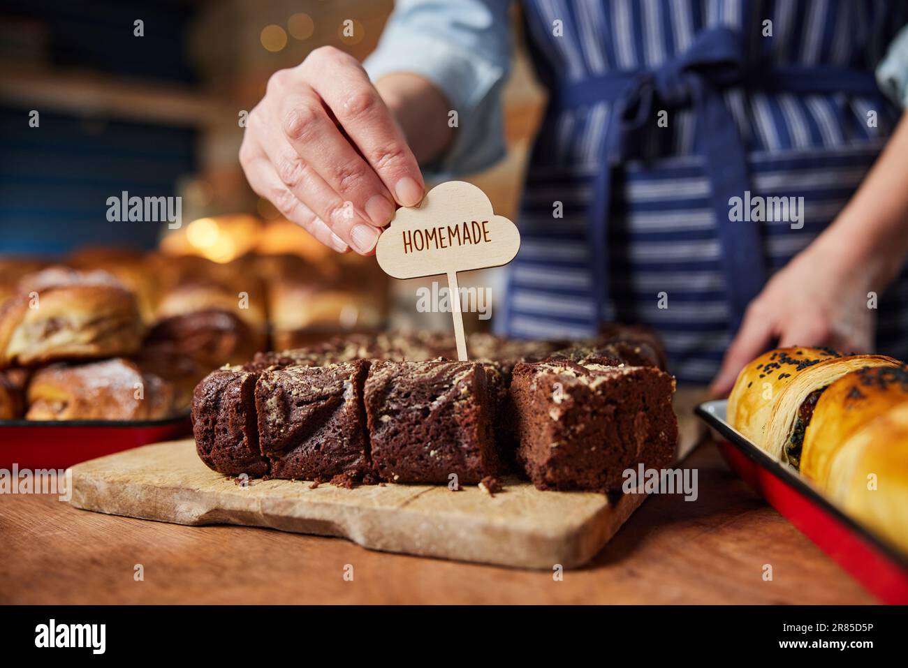 Sales Assistant In Bakery Putting Homemade Label Into Freshly Baked ...